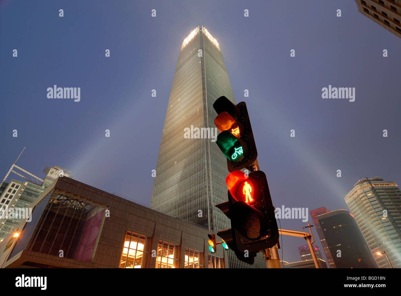 Red yellow green traffic light at the blue hour in front of a modern ...