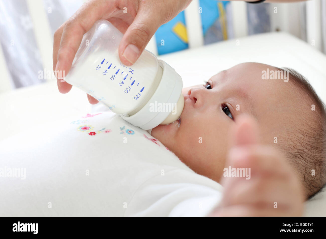 Baby drinking milk in the bottle Stock Photo - Alamy