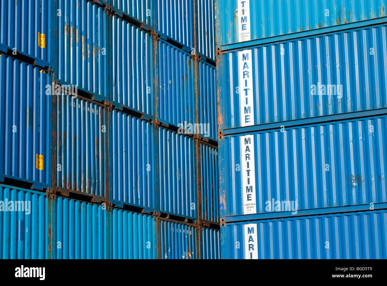 Bright blue shipping containers stacked up Stock Photo - Alamy