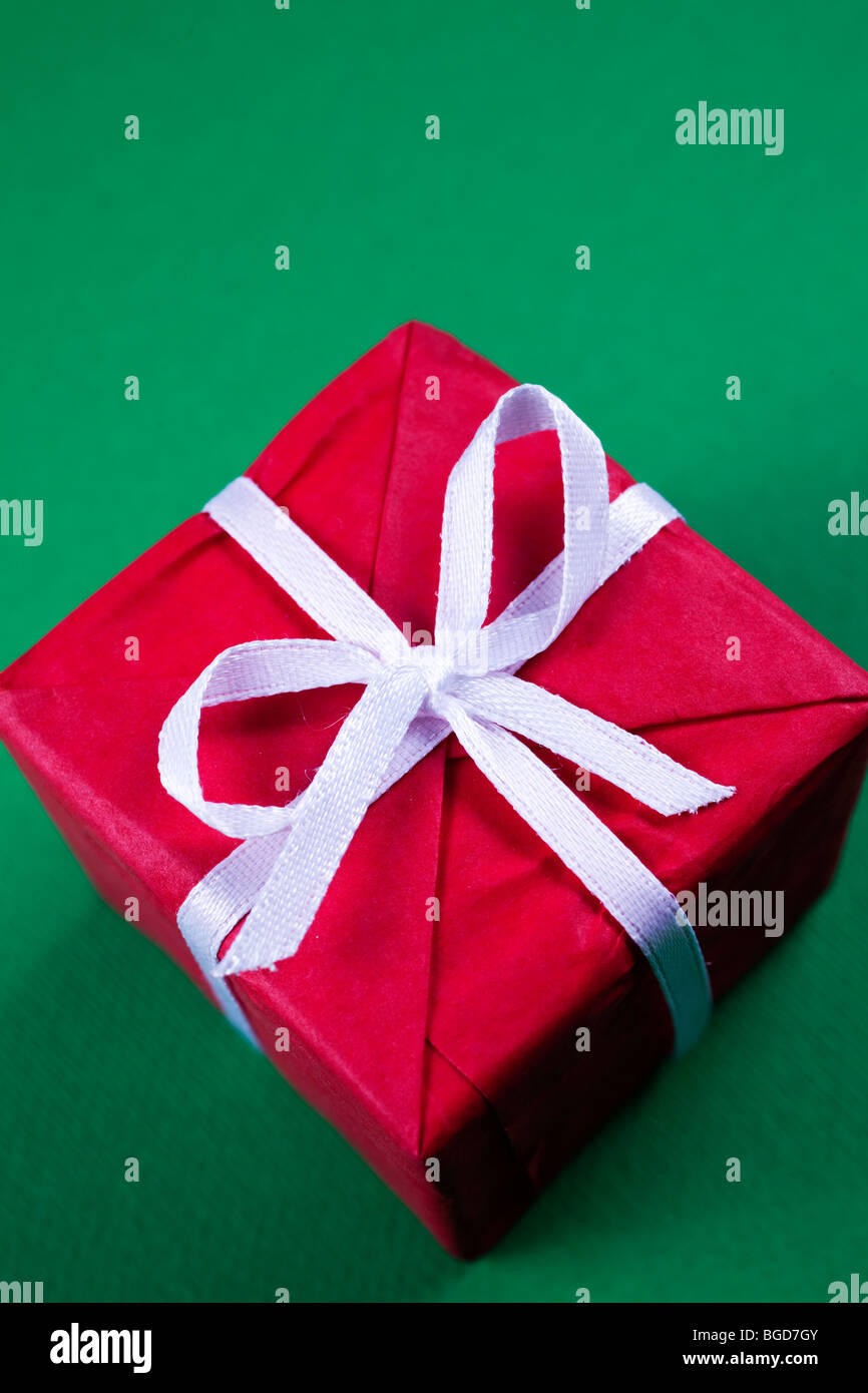 small present on green background Stock Photo - Alamy