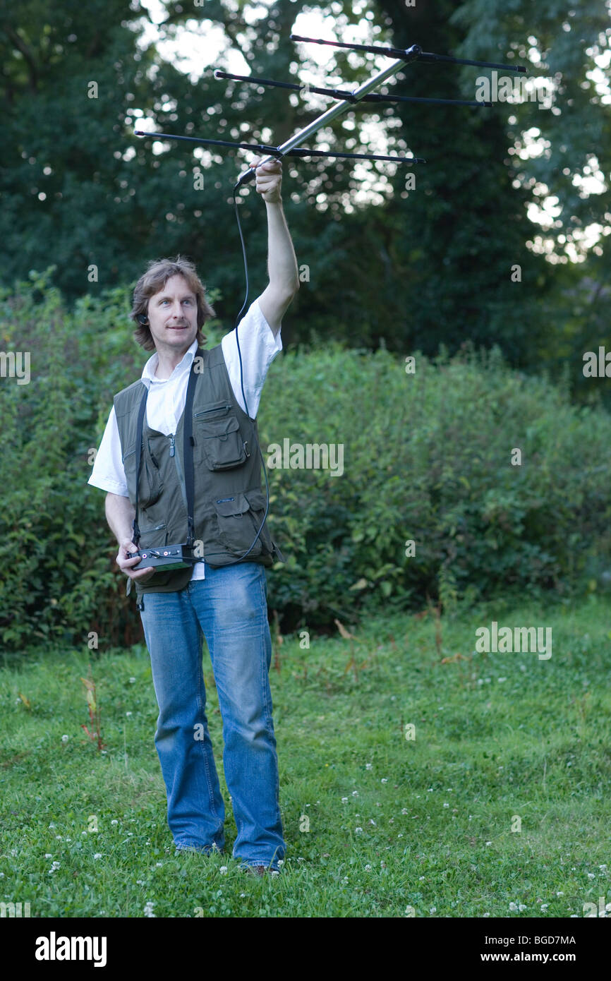 Bat Researcher with monitoring equipment locating animal positions ...