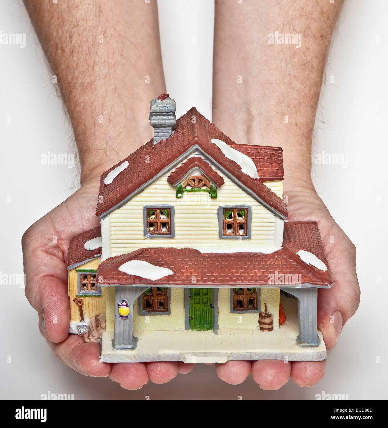 mans two hands holding miniature house Stock Photo - Alamy