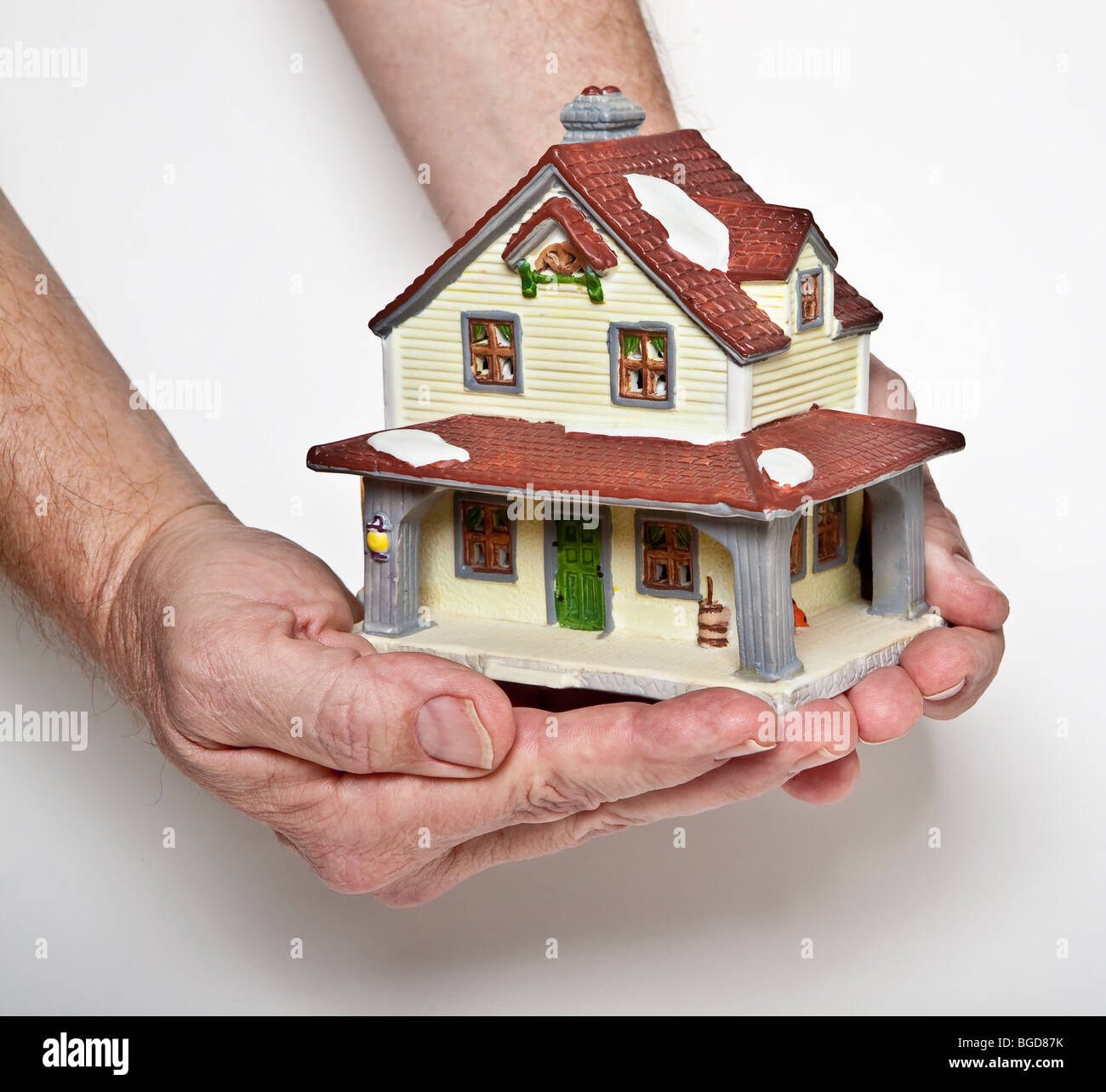 mans two hands holding miniature house Stock Photo - Alamy