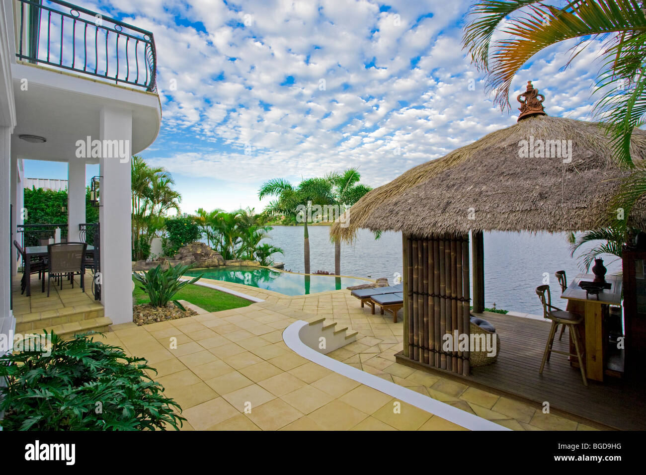 luxury mansion outside deck with Bali hut, bar and pool Stock Photo - Alamy