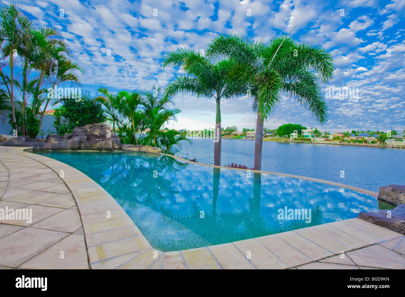 Infinity pool at luxury waterfront mansion Stock Photo - Alamy