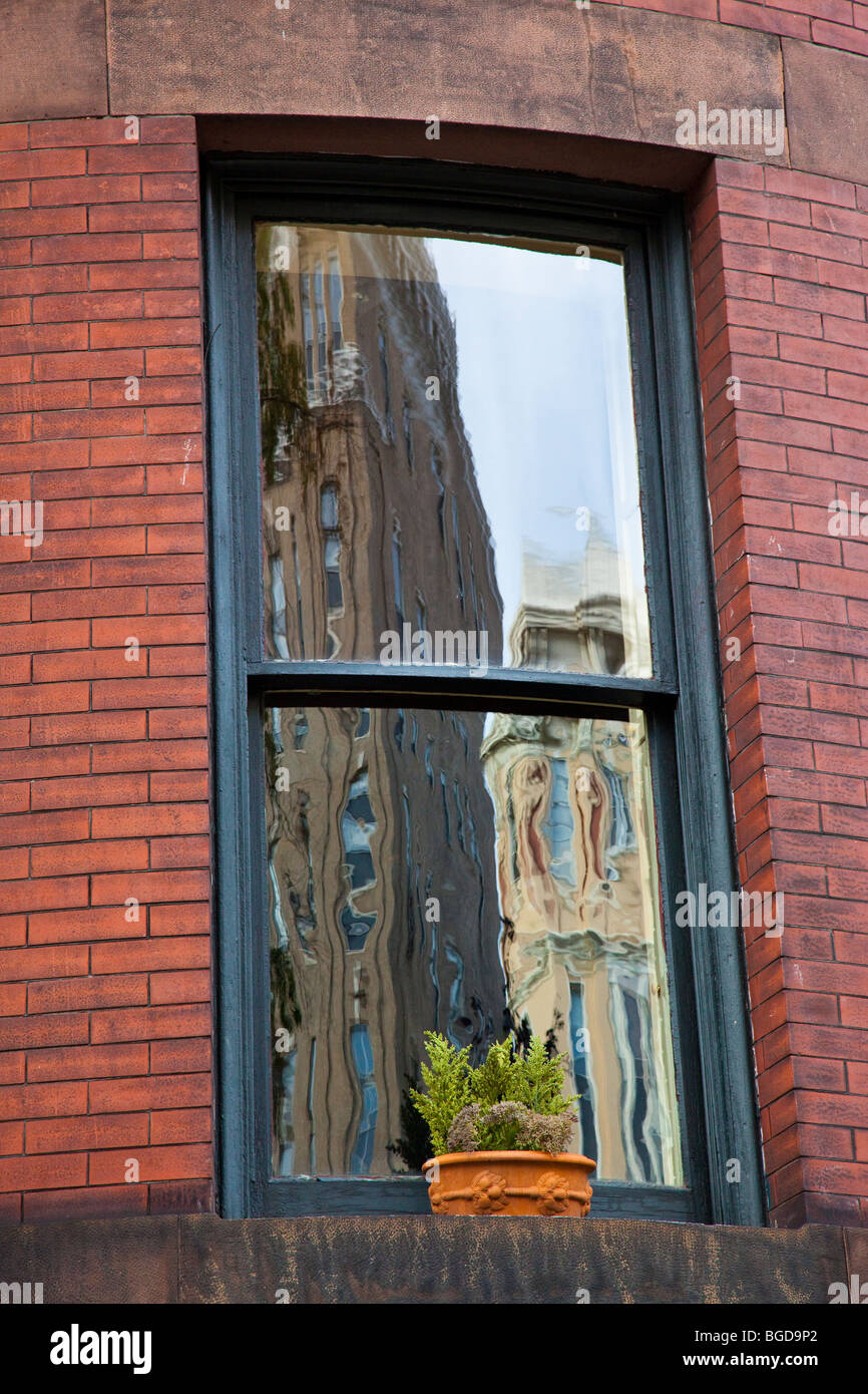 Historic buildings reflected off of a window on a historic house in ...