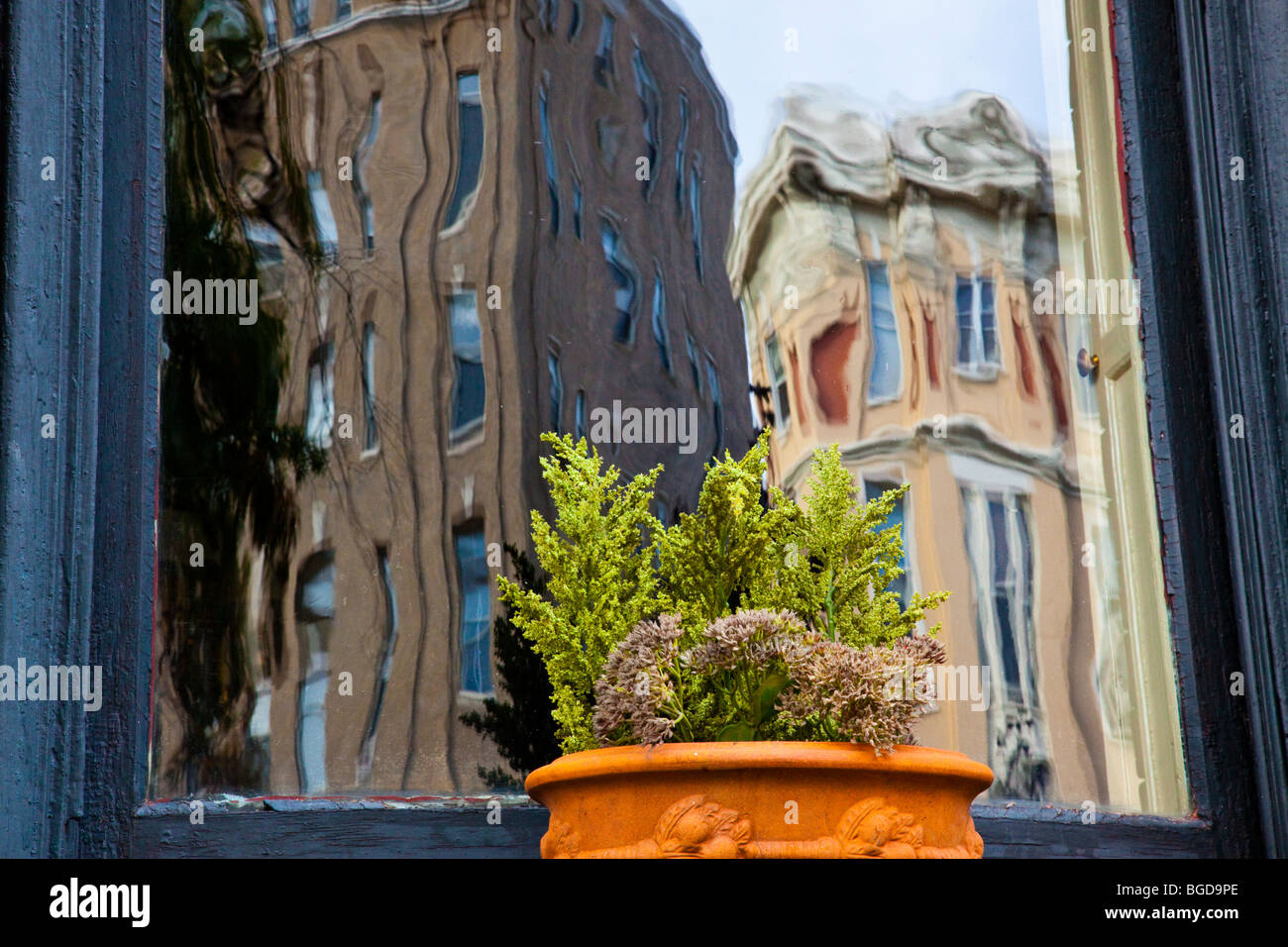 Historic buildings reflected off of a window on a historic house in ...