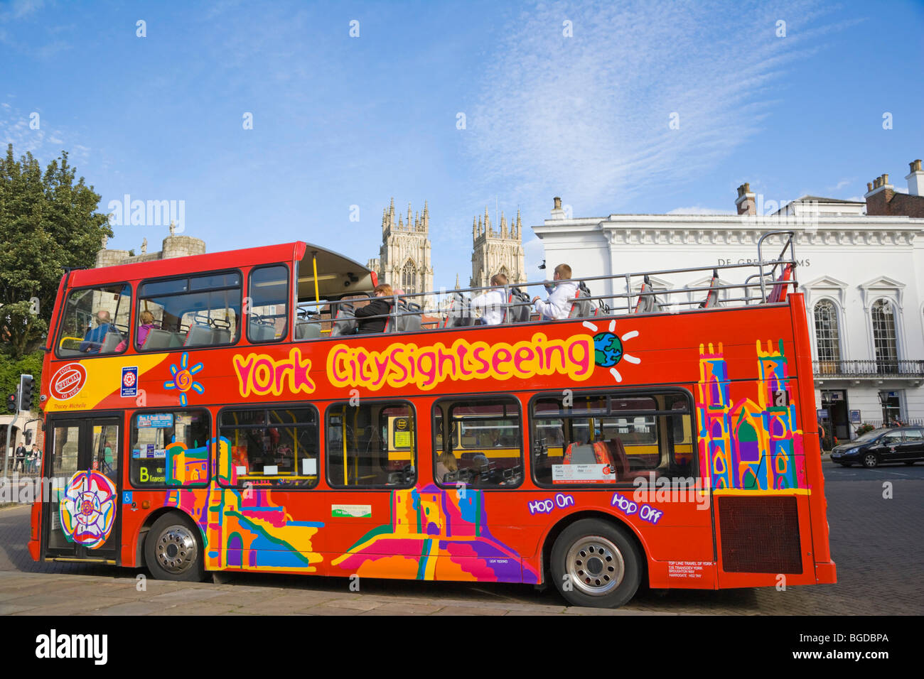 York CitySightseeing, tourist bus, against medieval York with York ...