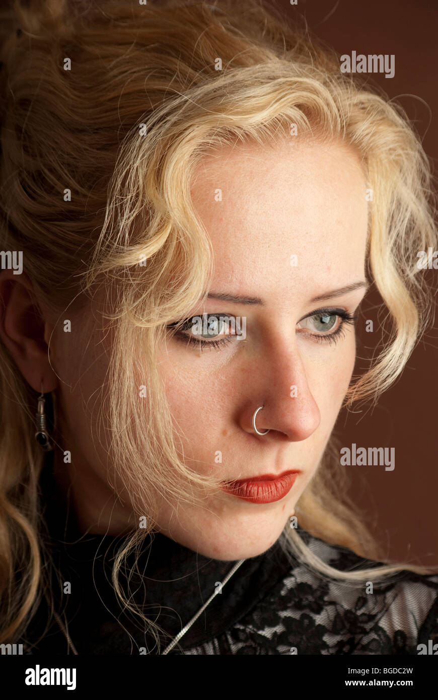 Young woman, blond, Gothic style with a serious expression on her face ...