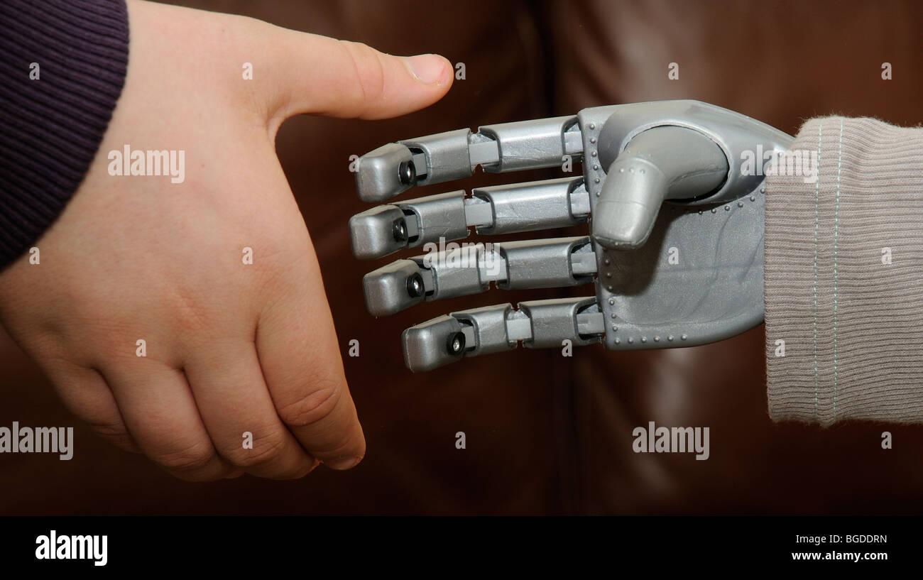 Human hand greeting and shaking hands with a bionic hand Stock Photo ...