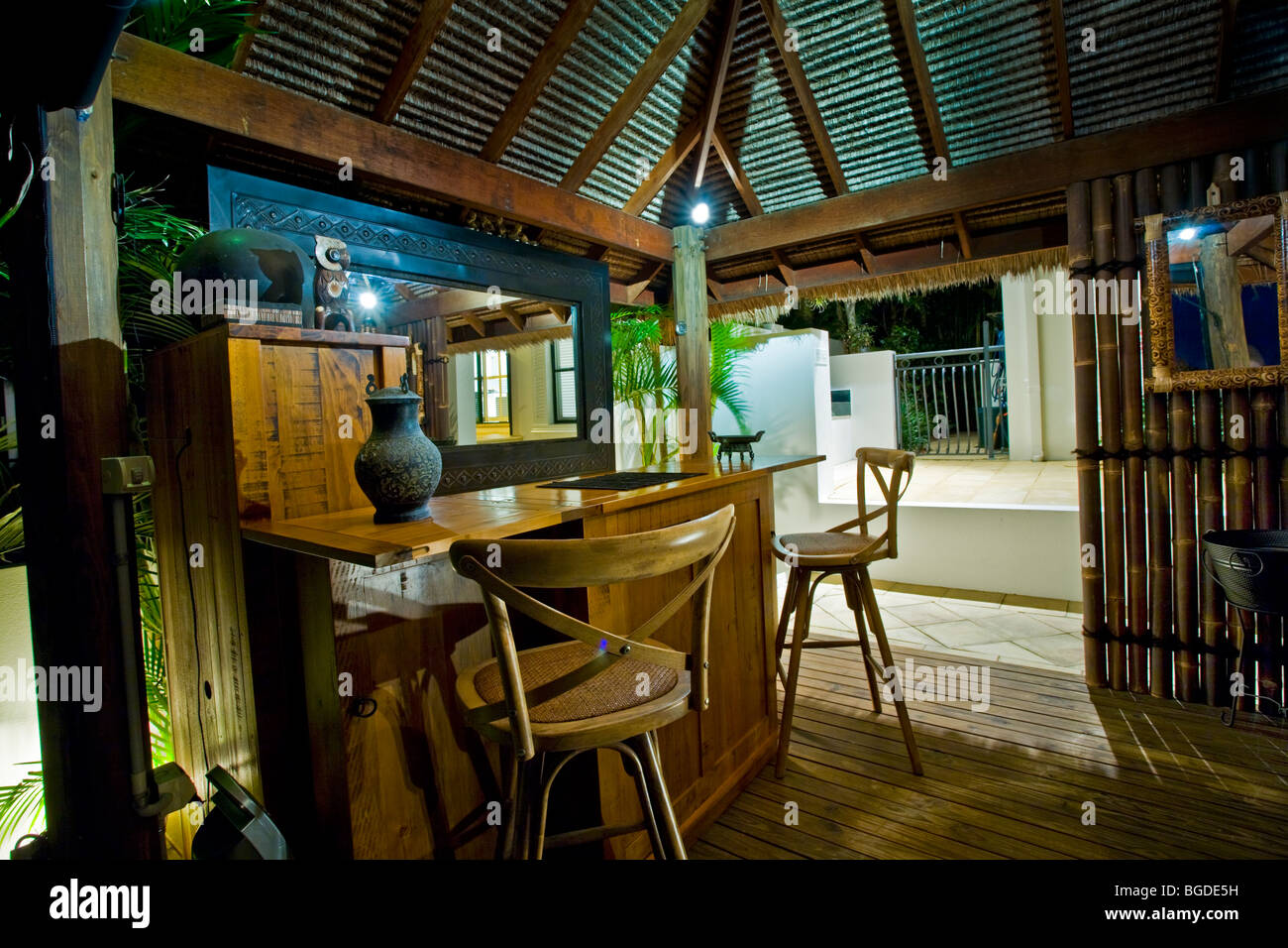 Luxurious mansion exterior at dusk with Bali hut and bar Stock Photo ...