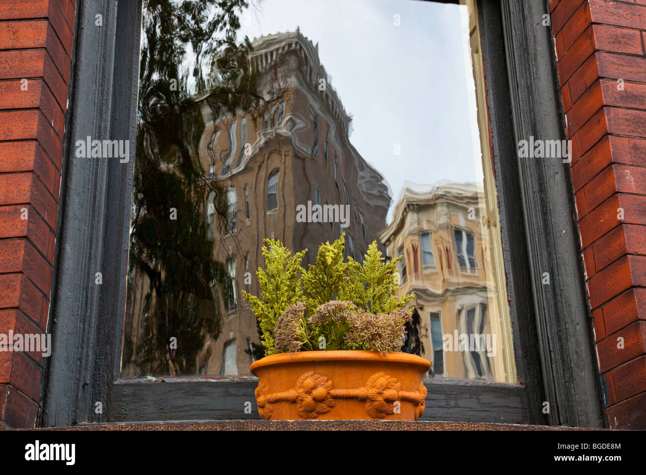 Historic buildings reflected off of a window on a historic house in ...