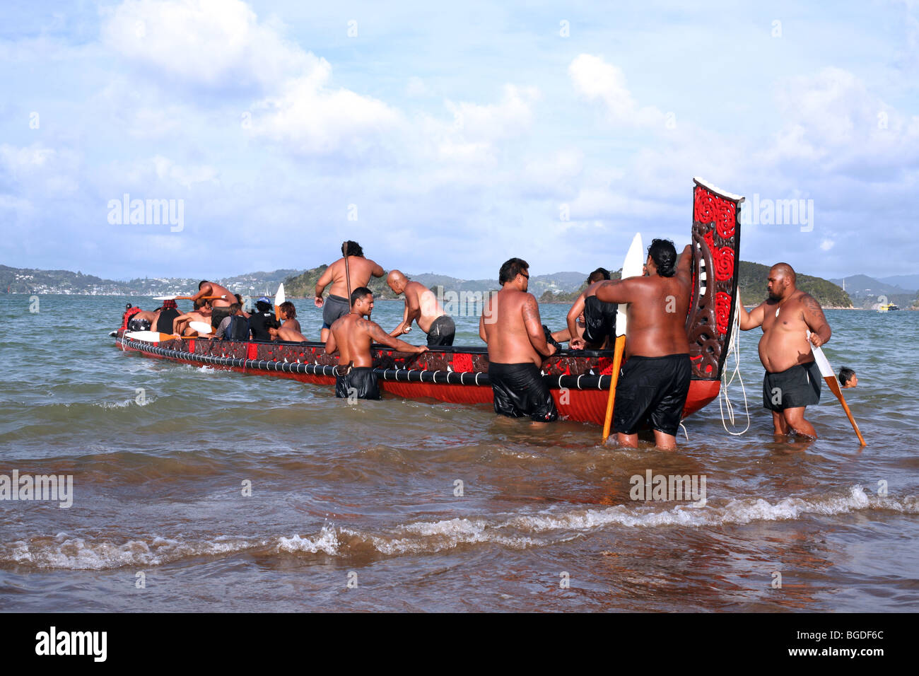Maori warriors of a Waka Taua (war canoe) preparing Waka on Te Ti Bay ...