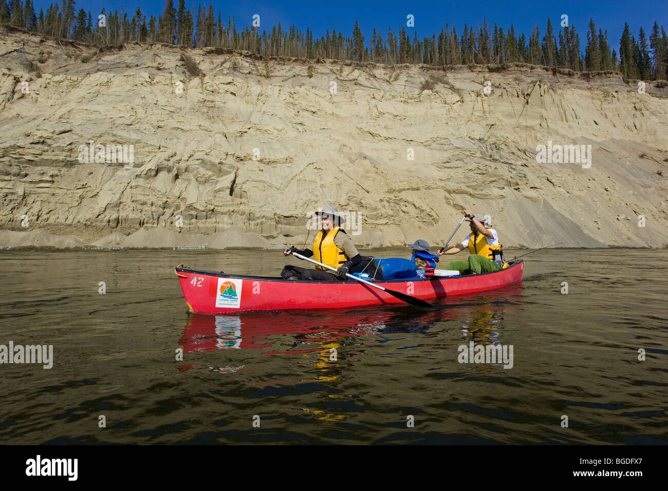 Family with young boy in a canoe, paddling, canoeing on Teslin River ...
