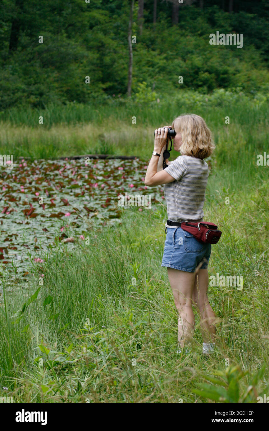 Woman Birdwatcher by Wetlands - Vertical Stock Photo - Alamy