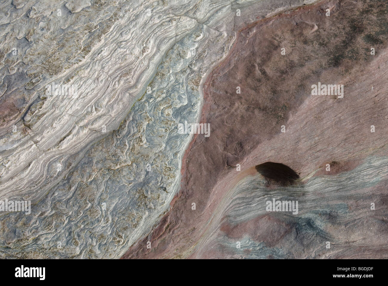 artistic creative abstract strata and patterns on rocks on the beach ...