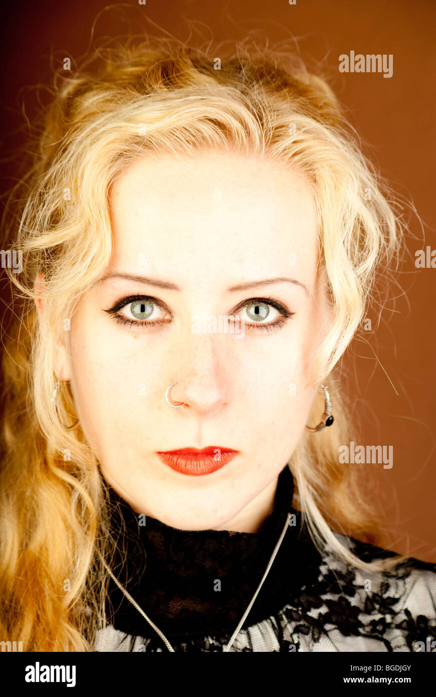 Young woman, blond, Gothic style with a serious expression on her face ...