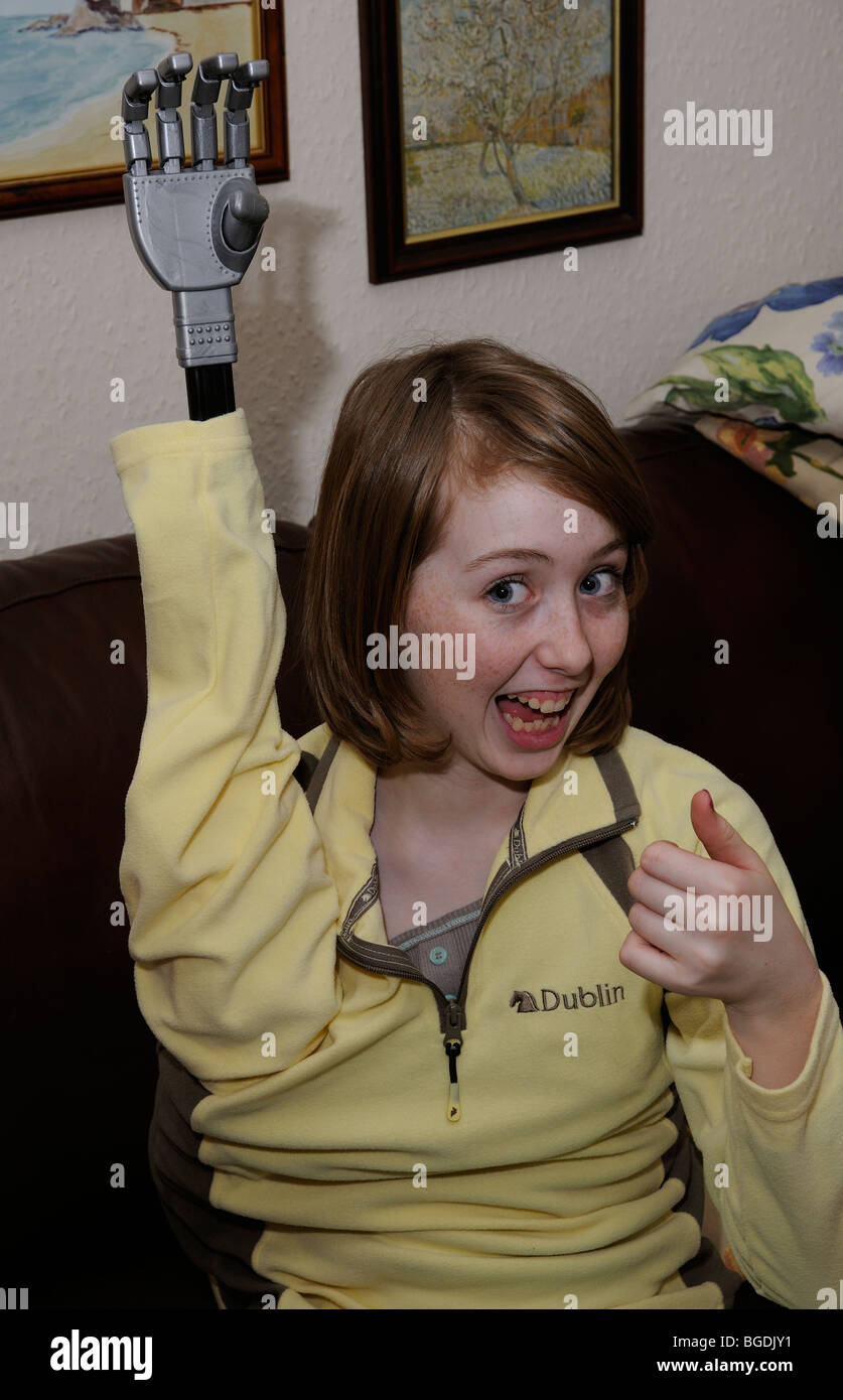 Young girl playing with a plastic bionic hand Stock Photo - Alamy