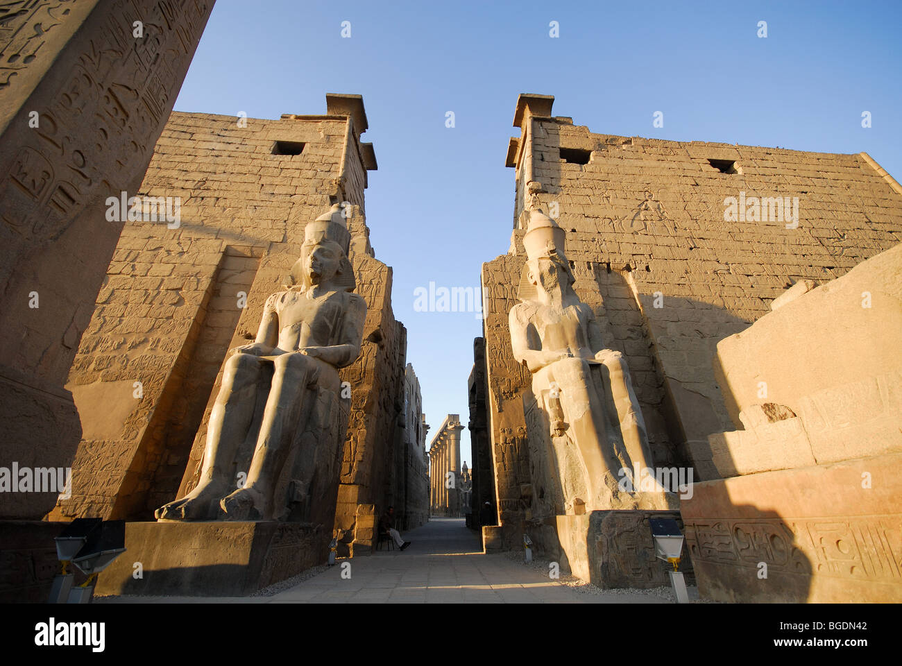 LUXOR, EGYPT. The Colossi of Ramses II and pylon at Luxor Temple Stock ...