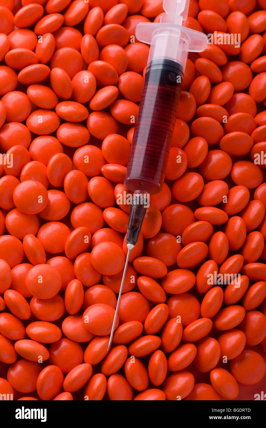 object on red - Medical Tablets and syringe close up Stock Photo - Alamy