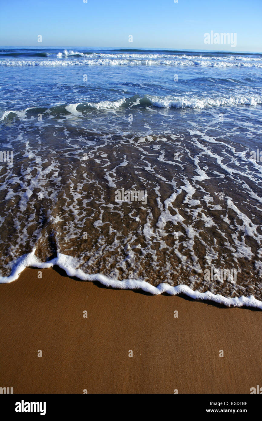 Waves reaching sea shore sunny hi-res stock photography and images - Alamy