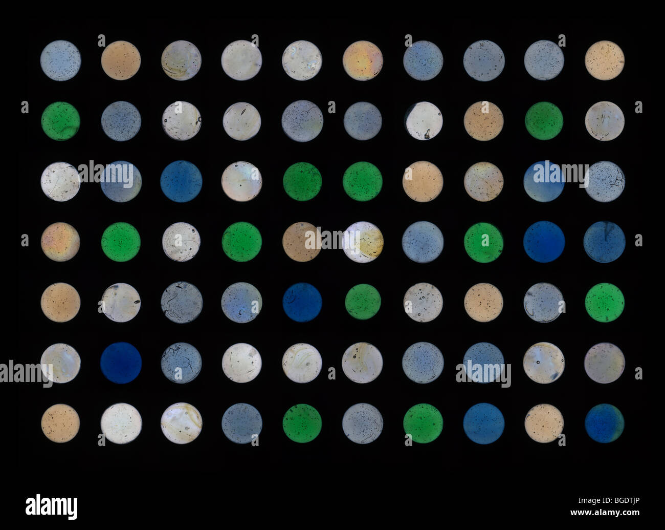 lots of marbles in a line black background Stock Photo - Alamy