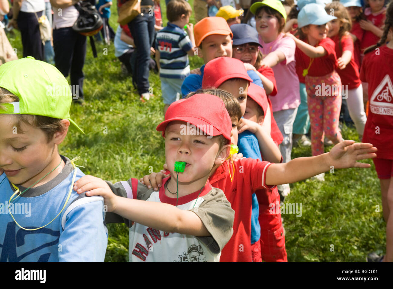 Happy children in line outdoor Stock Photo - Alamy