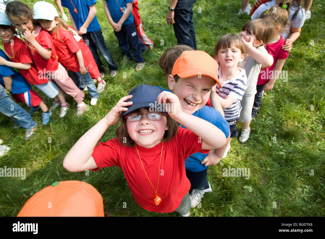 Happy children in line outdoor Stock Photo - Alamy
