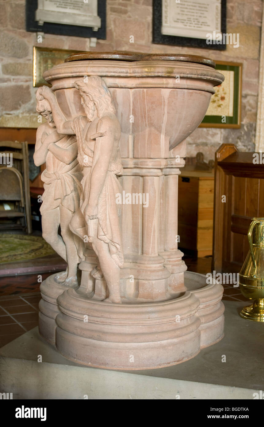 Adorned with carved figures and vertical pillars is the stone Font of ...