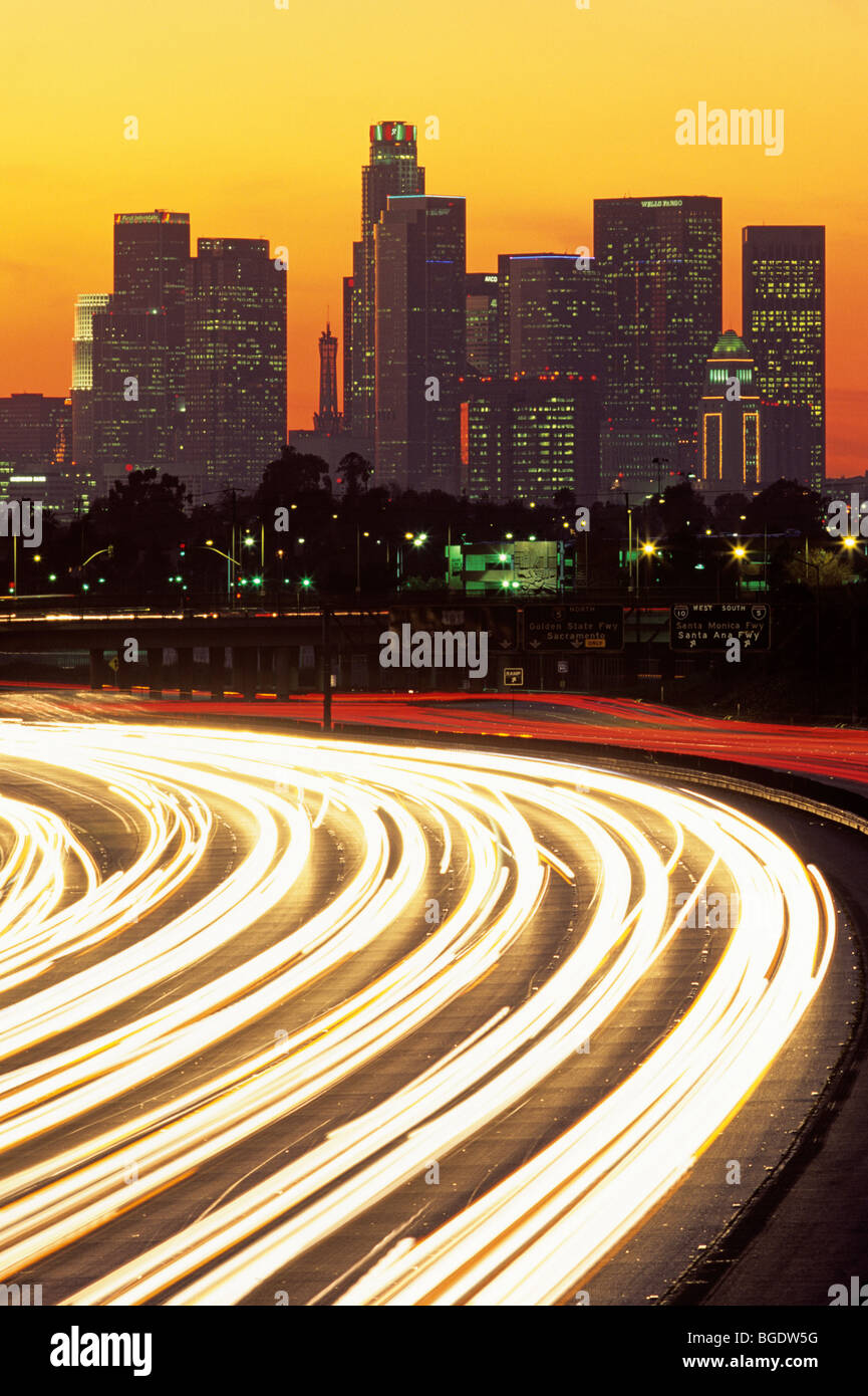 Retro image, Sunset over LA Downtown District with skyscrapers with car ...