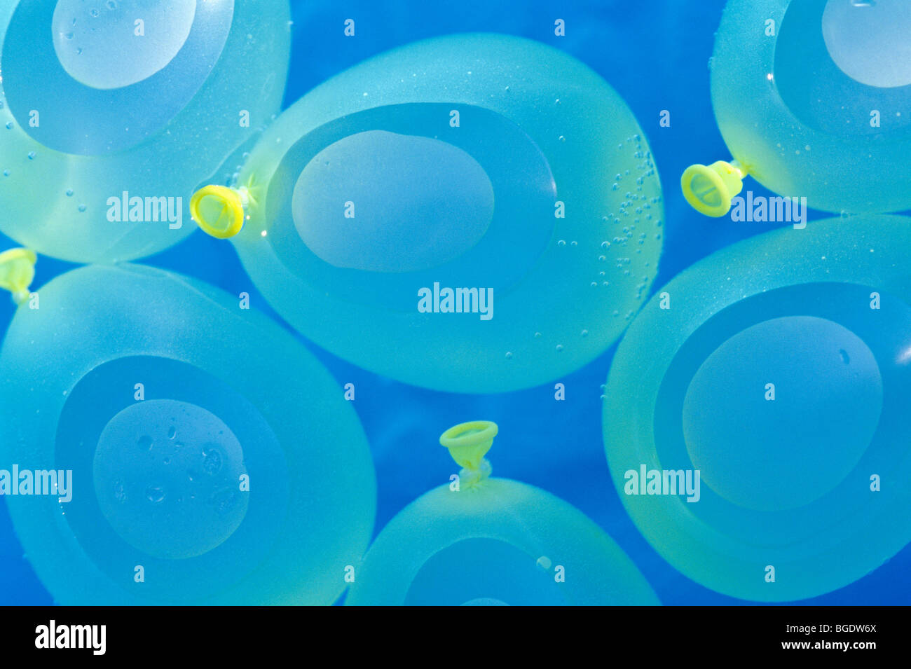 Water balloons in pool floating, yellow and blue balloons, patterns ...