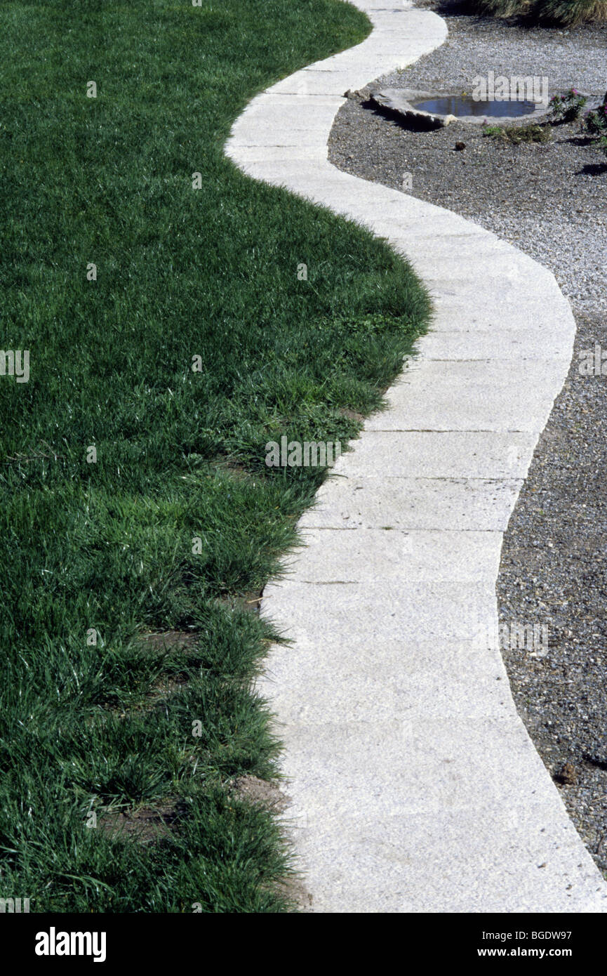 Curvy white brick path in park along garden Stock Photo - Alamy
