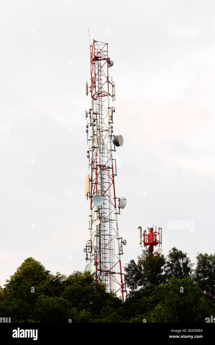 A telecommunication tower with trees in the foreground Stock Photo - Alamy