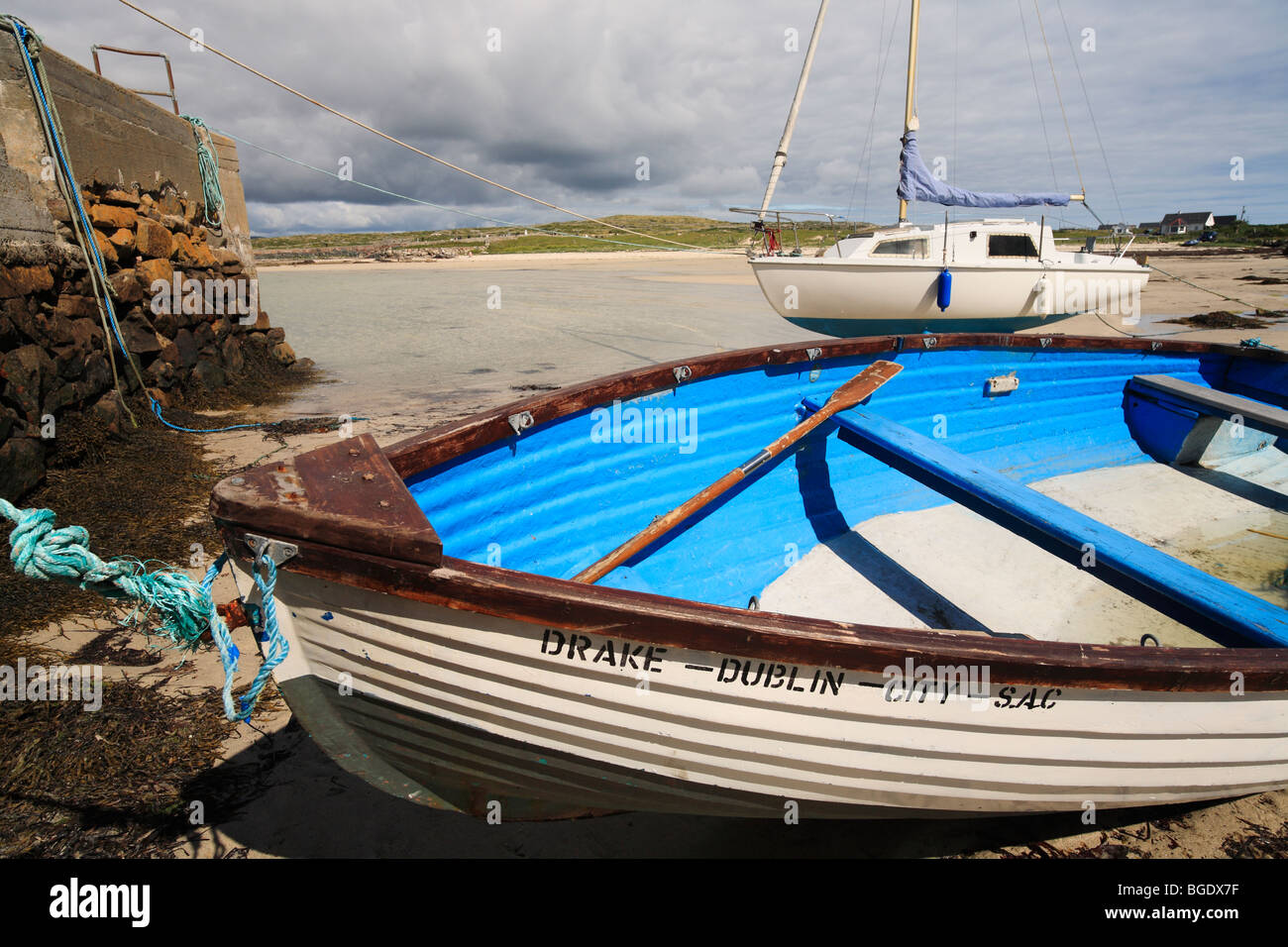 fishing boat and sailing boat at the beach in Carna near Roundstone ...