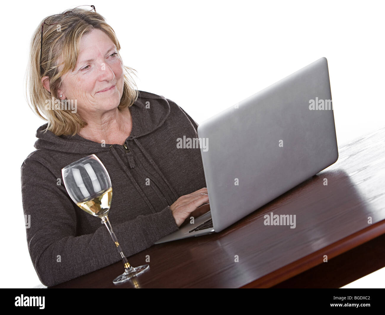 Shot of a Senior Lady Sitting Down and Enjoying sometime on her Laptop ...