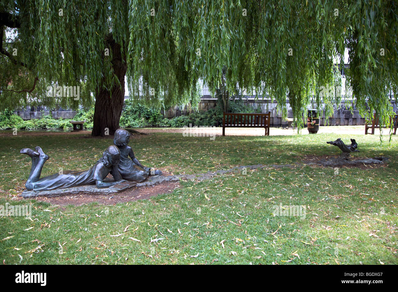 Bronze statue of Alice in Wonderland watching the White Rabbit run for ...