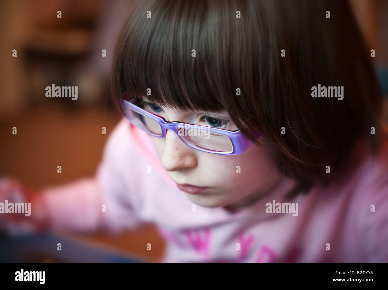 9 year old girl concentrates on computer young Stock Photo - Alamy