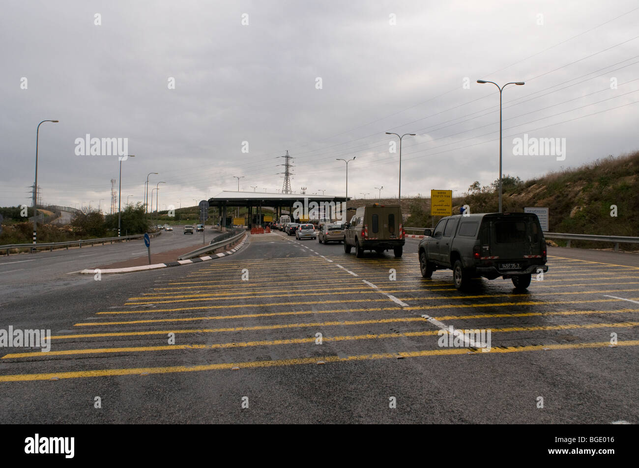 Israeli cars driving through a checkpoint on Route 443 in the West Bank ...
