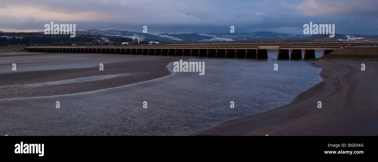 Railway Bridge over the Estuary at Arnside with snow in the background ...