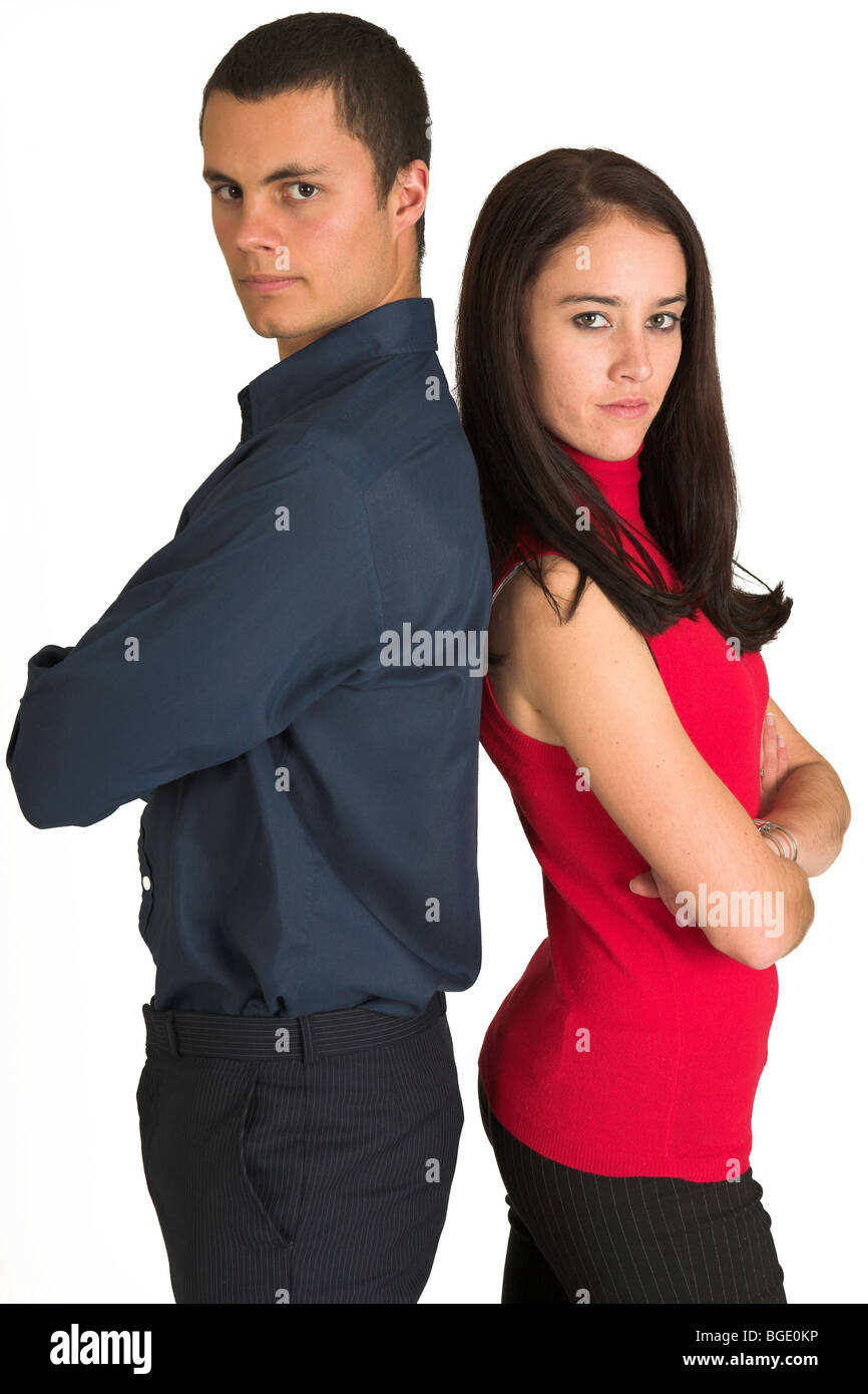 Two co-workers standing back to back on a white background Stock Photo ...