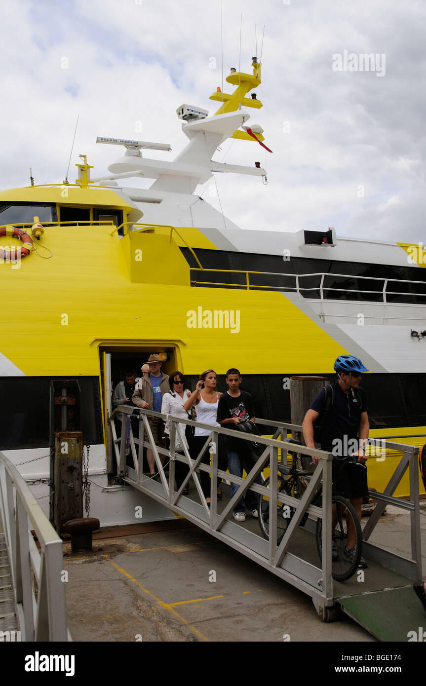 Passengers disembark from a high speed commuter ferry at Ryde Pier Isle ...