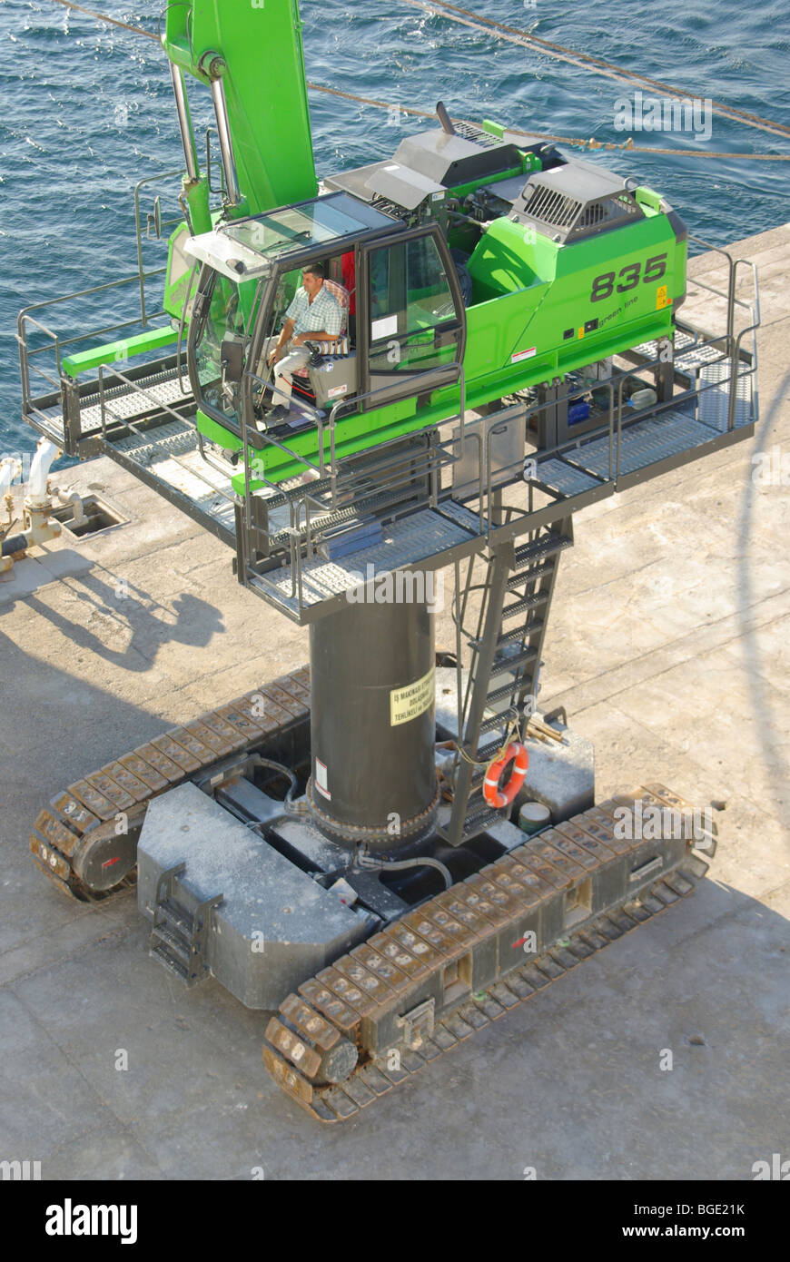 Dockyard mobile crane with caterpillar tracks and driver Stock Photo ...
