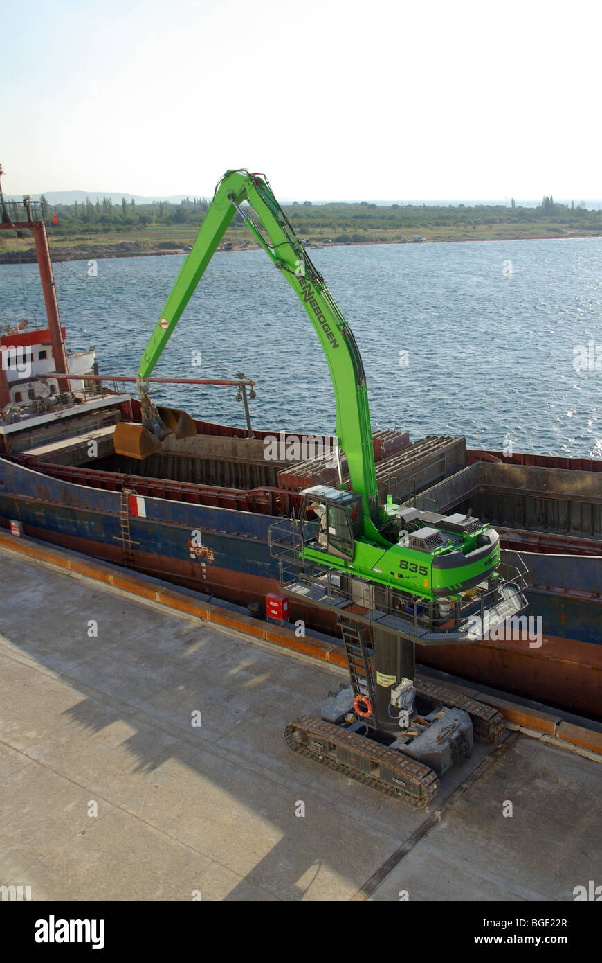 Dockyard mobile crane with caterpillar tracks and driver alongside ...