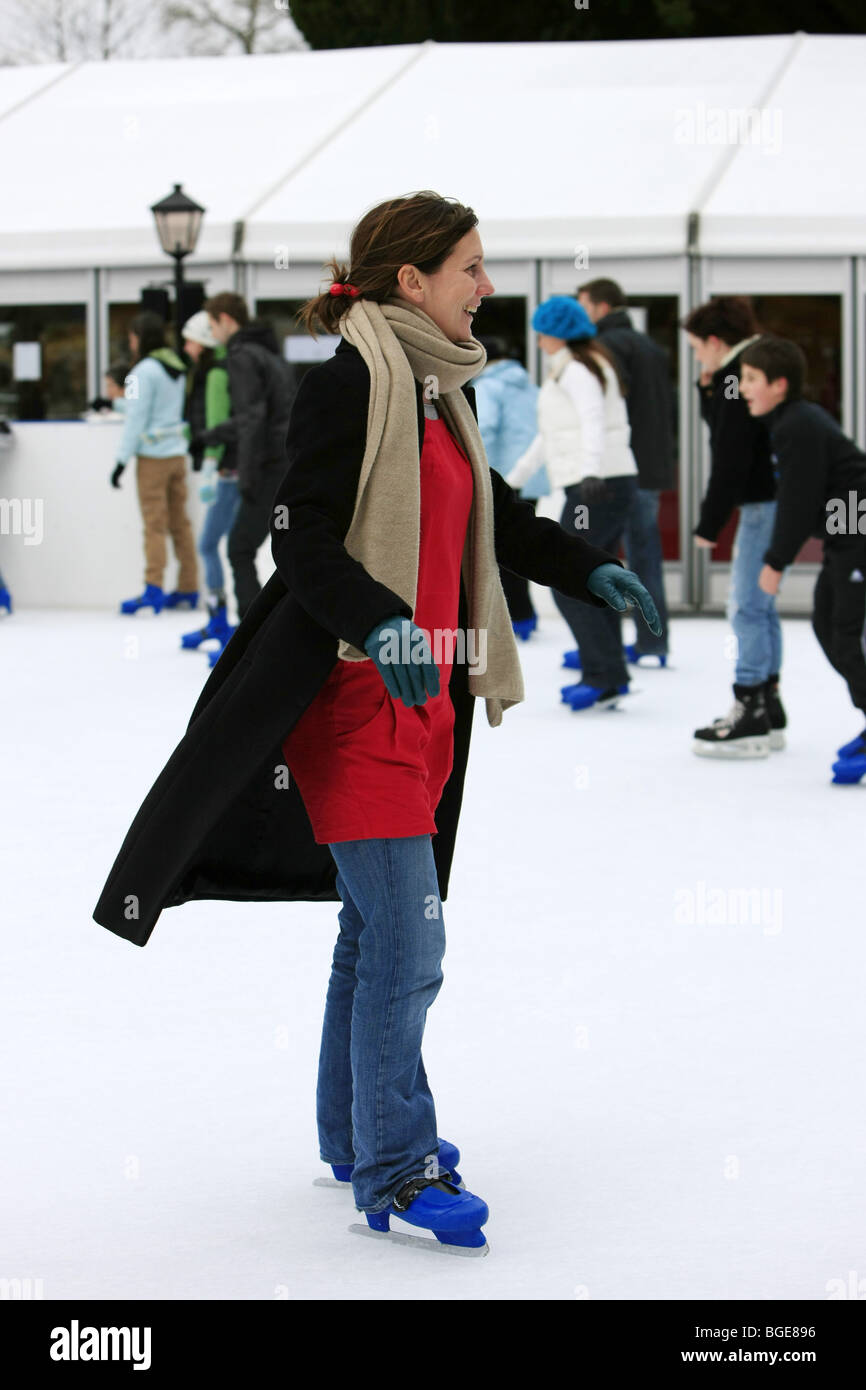 Young adult woman ice skating at an outdoor rink Stock Photo - Alamy
