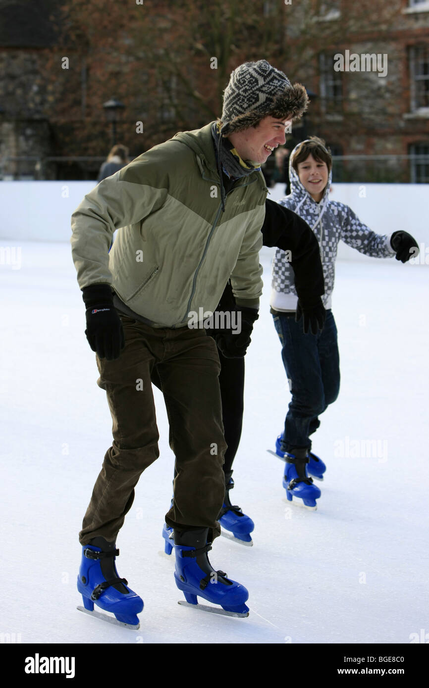 Teenage boys ice skating at an outdoor rink Stock Photo - Alamy