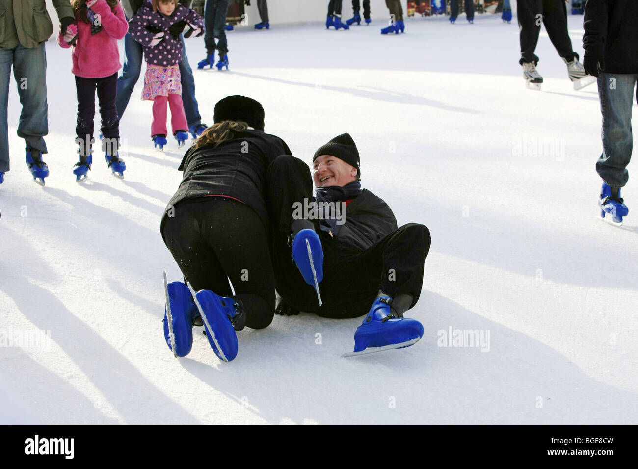 A man being helped onto his feet after falling whilst People of all ...