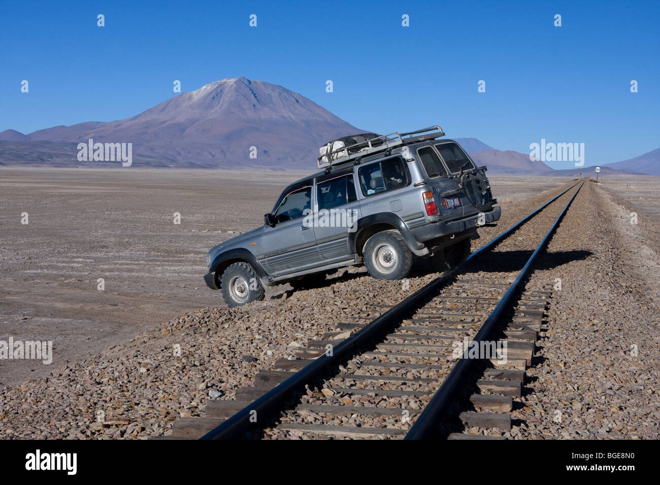 4x4 jeep crossing railway line high on the Altiplano on the Chalviri ...