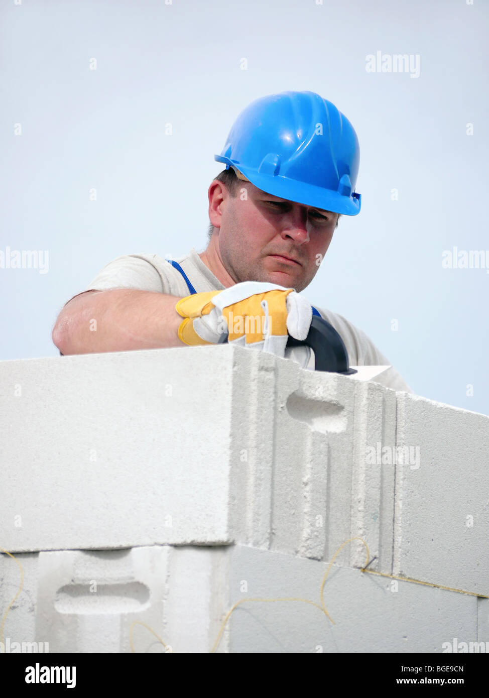 Mason applying mortar using trowel onto house wall brick layer Stock ...