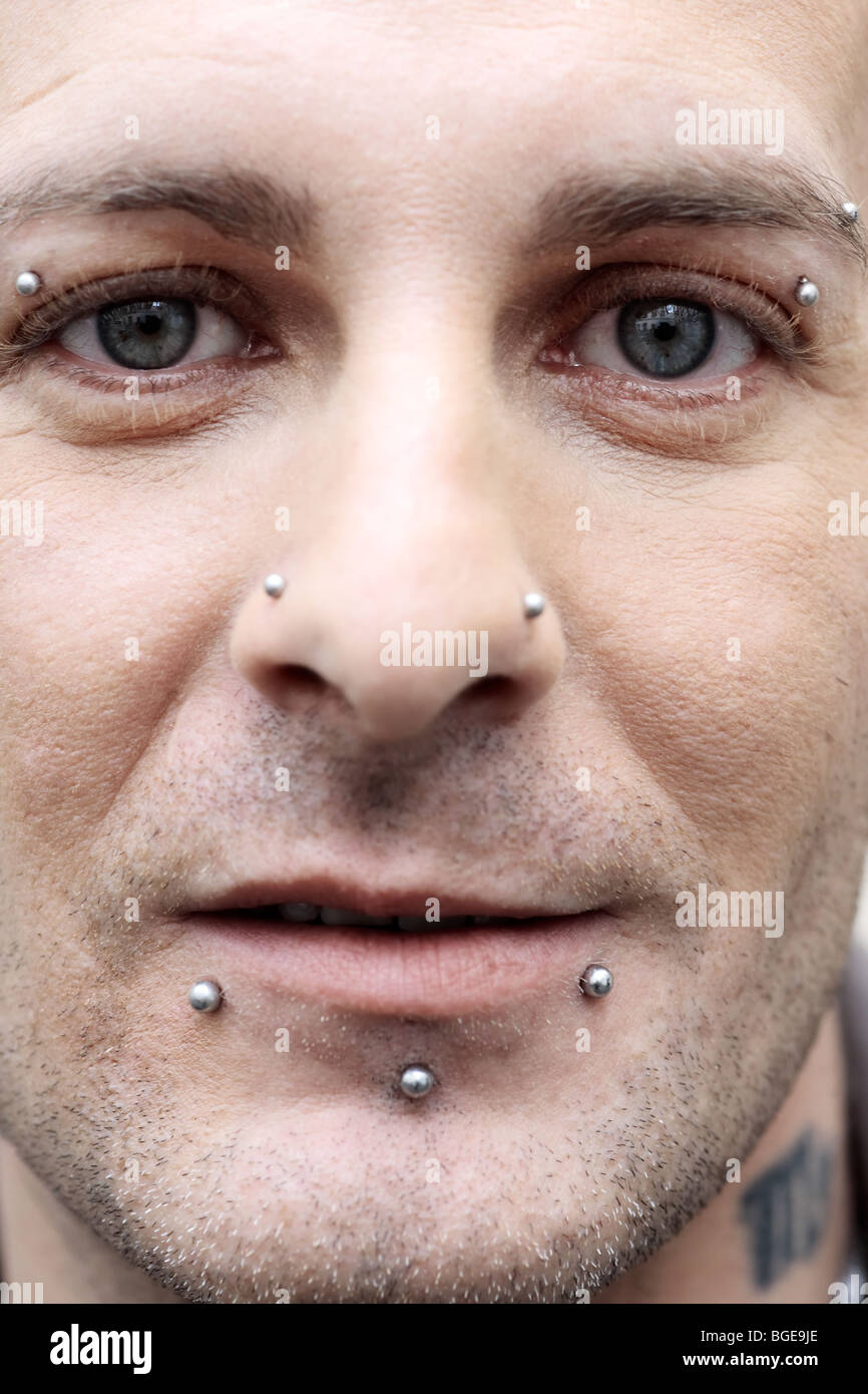 portrait of a man with piercing and tattoos Stock Photo - Alamy