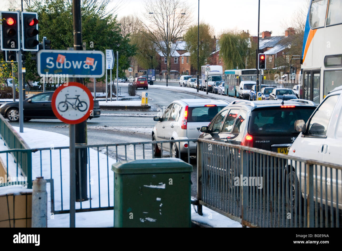 Cars waiting at traffic lights on a busy road junction in Manchester ...